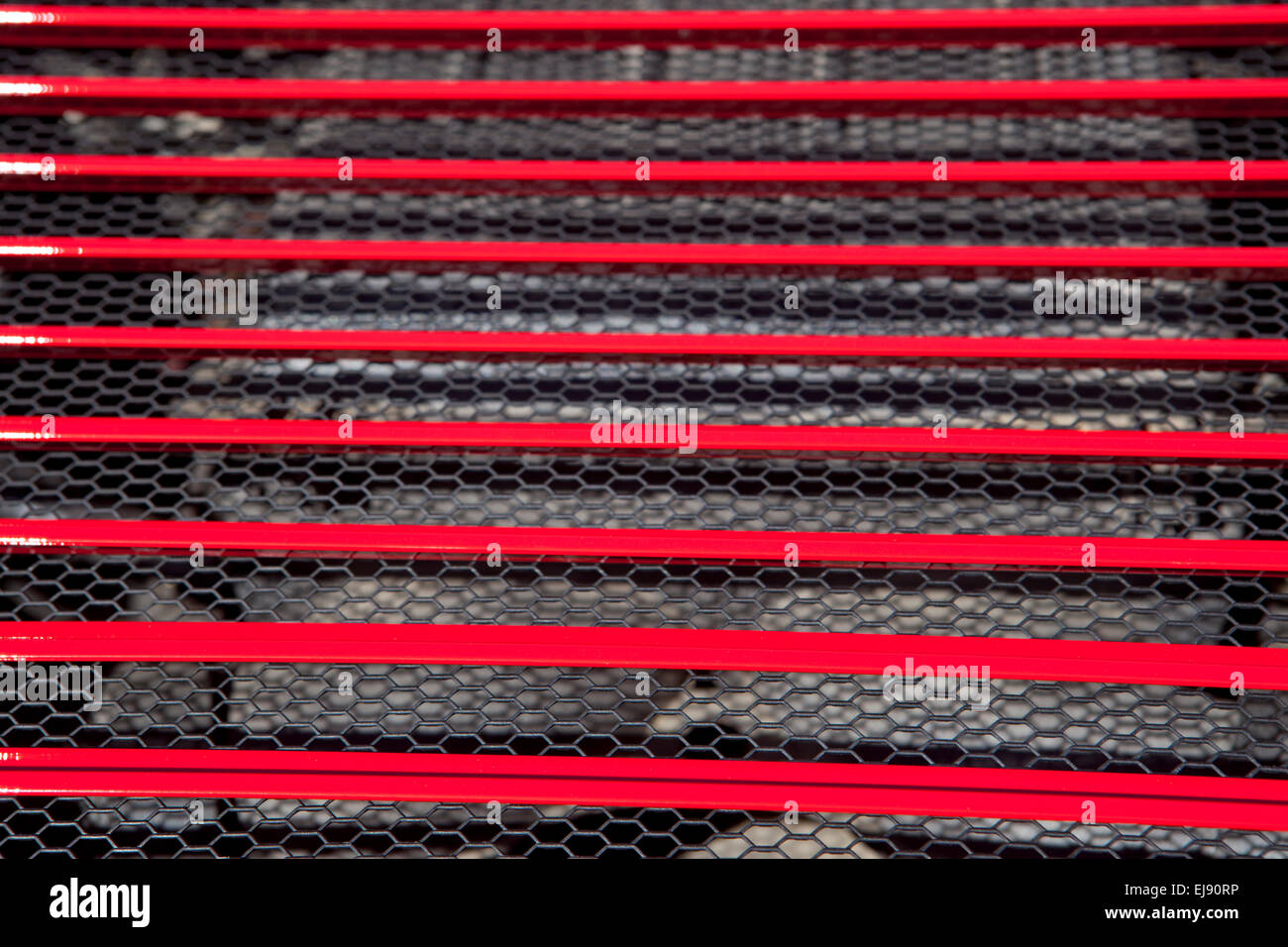 Red sports car engine grid. Detail of a luxury car Stock Photo - Alamy