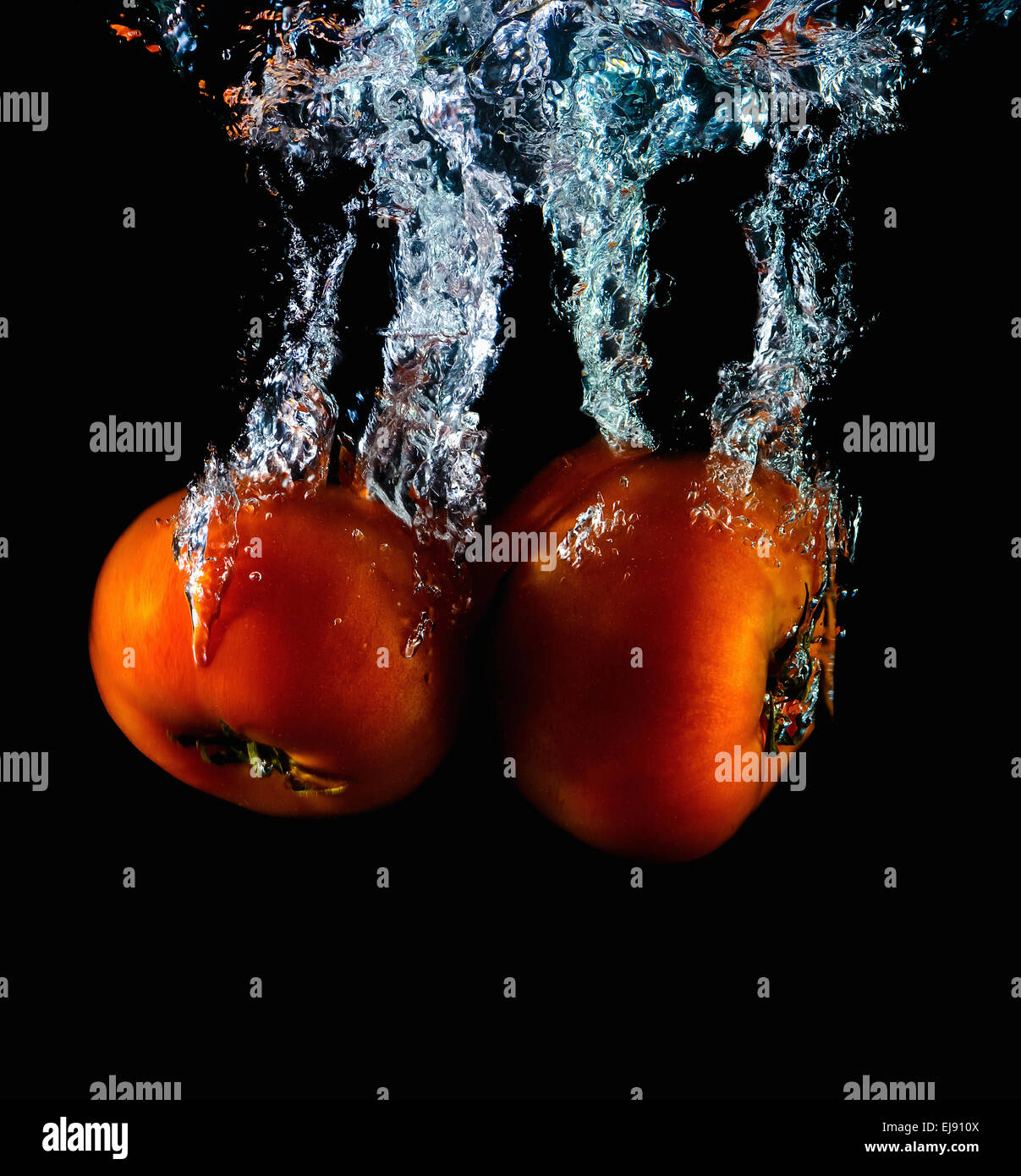 Fresh red tomato falling water hi-res stock photography and images - Alamy
