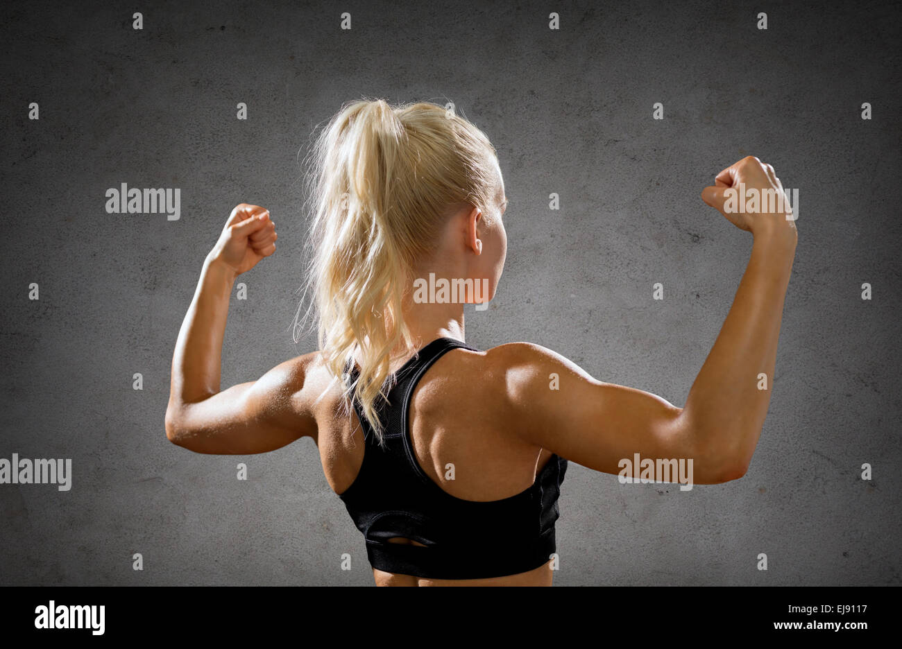 Rear view muscular woman flexing hi-res stock photography and images ...