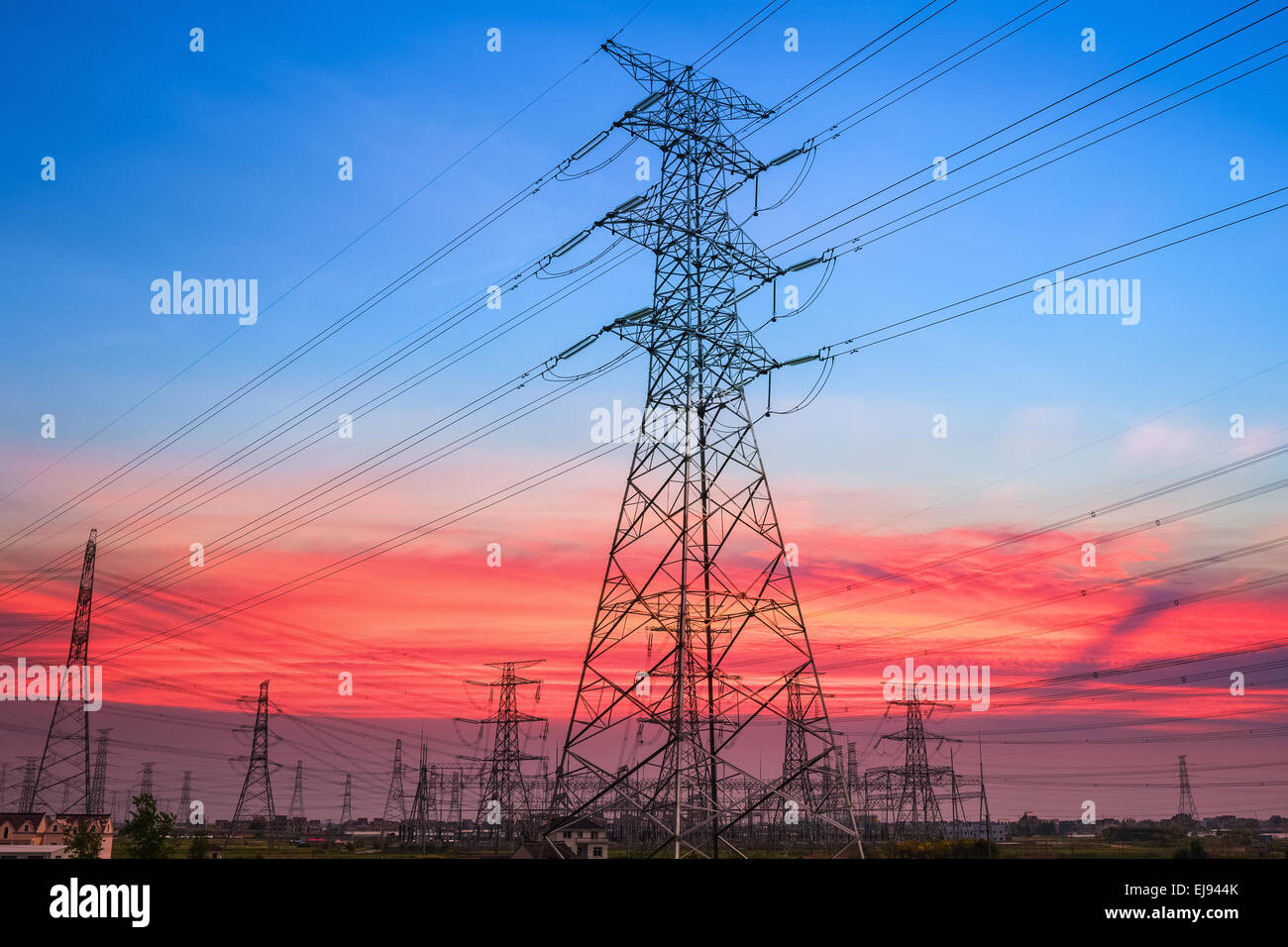electricity pylon in sunset Stock Photo - Alamy