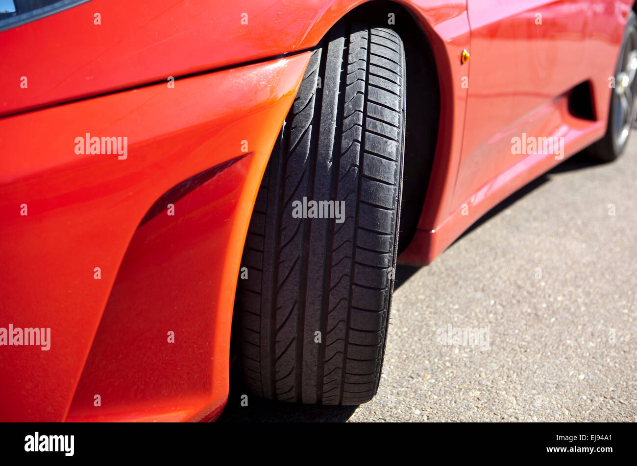 Red sports car front tyre. Selective focus Stock Photo - Alamy