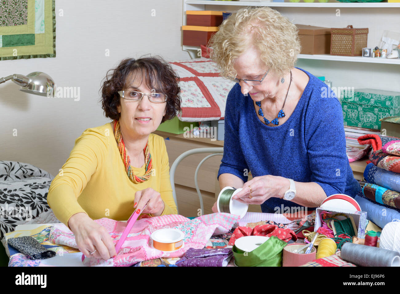 two women working on their patchwork in the workshop Stock Photo - Alamy