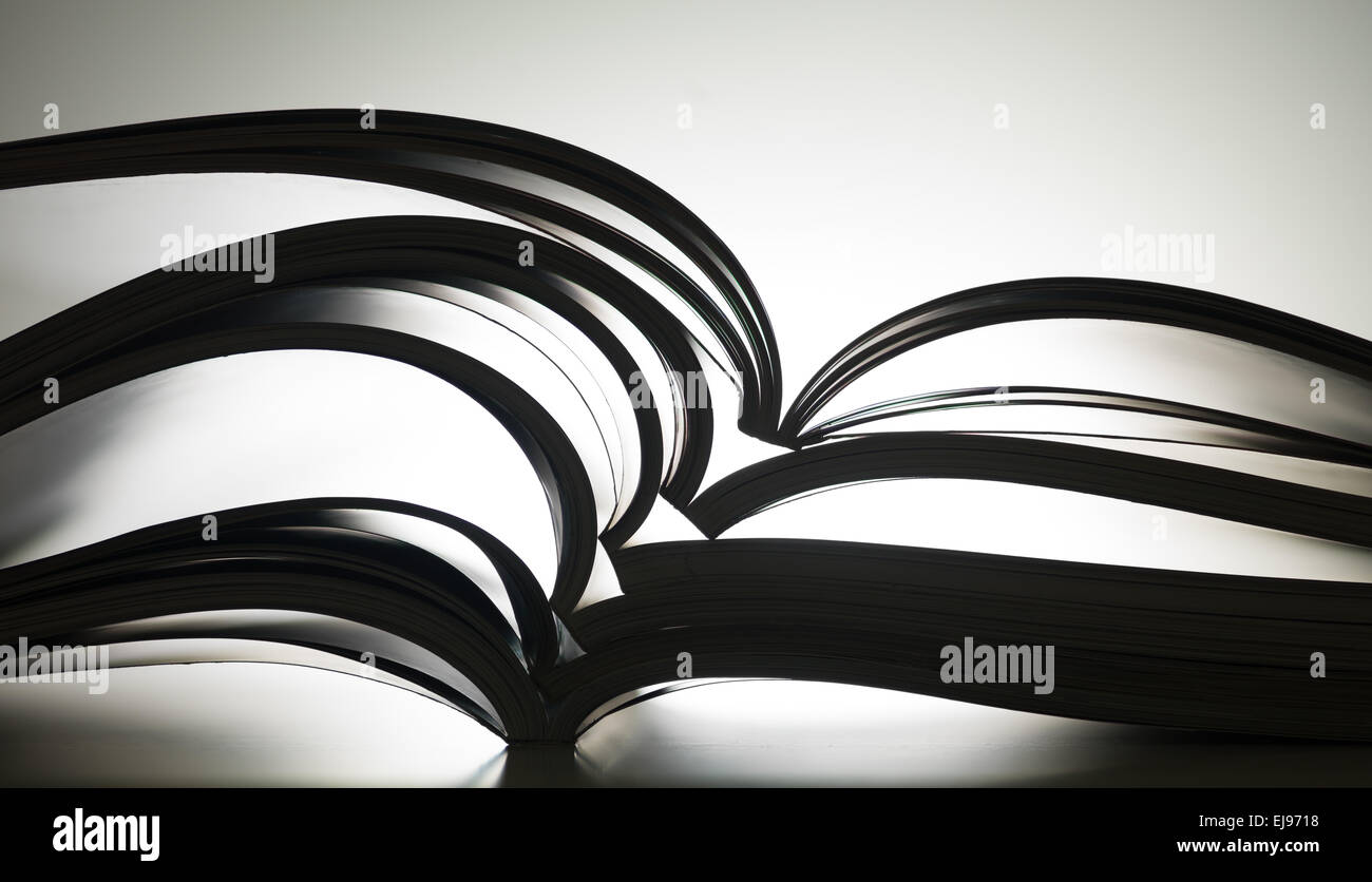 stack of opened magazines, backlit Stock Photo - Alamy