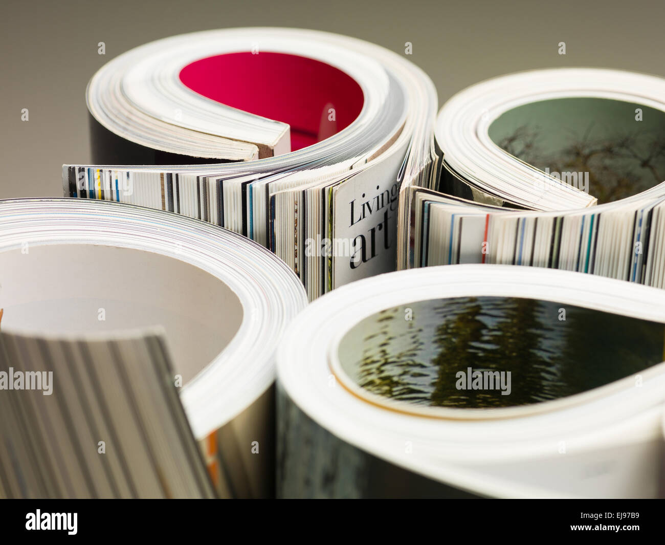 stack of rolled up magazines in a row Stock Photo - Alamy