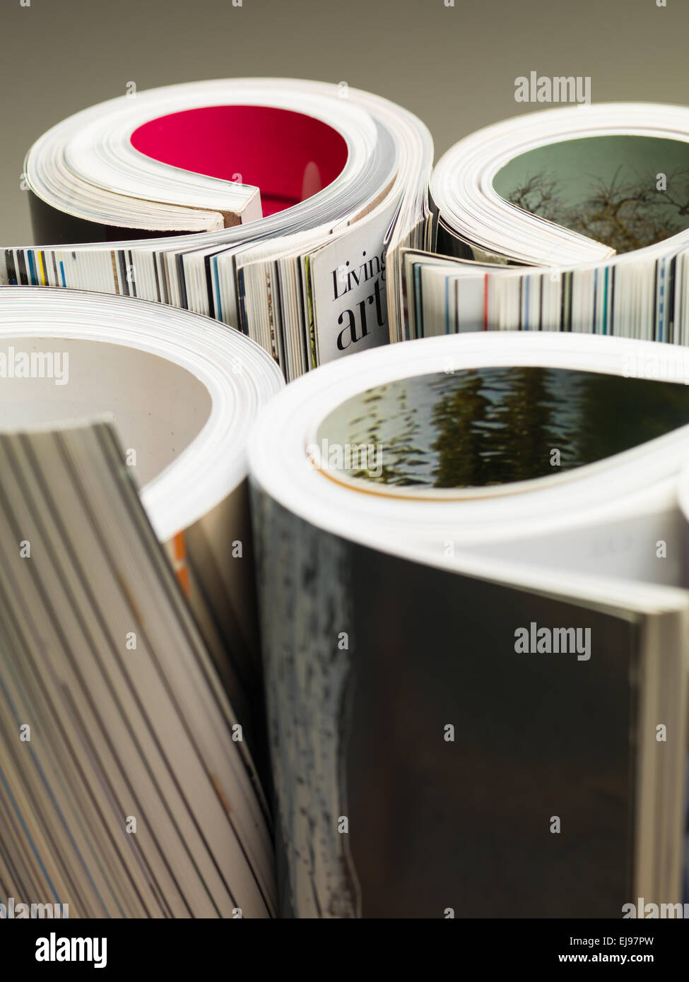 stack of rolled up magazines in a row Stock Photo - Alamy