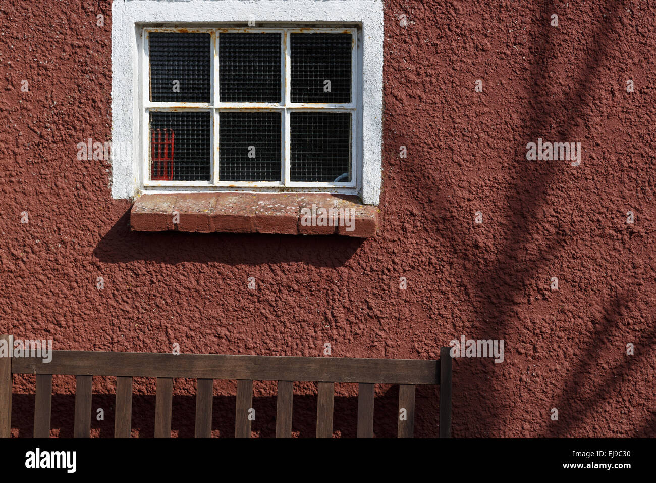 Bench under the window Stock Photo - Alamy