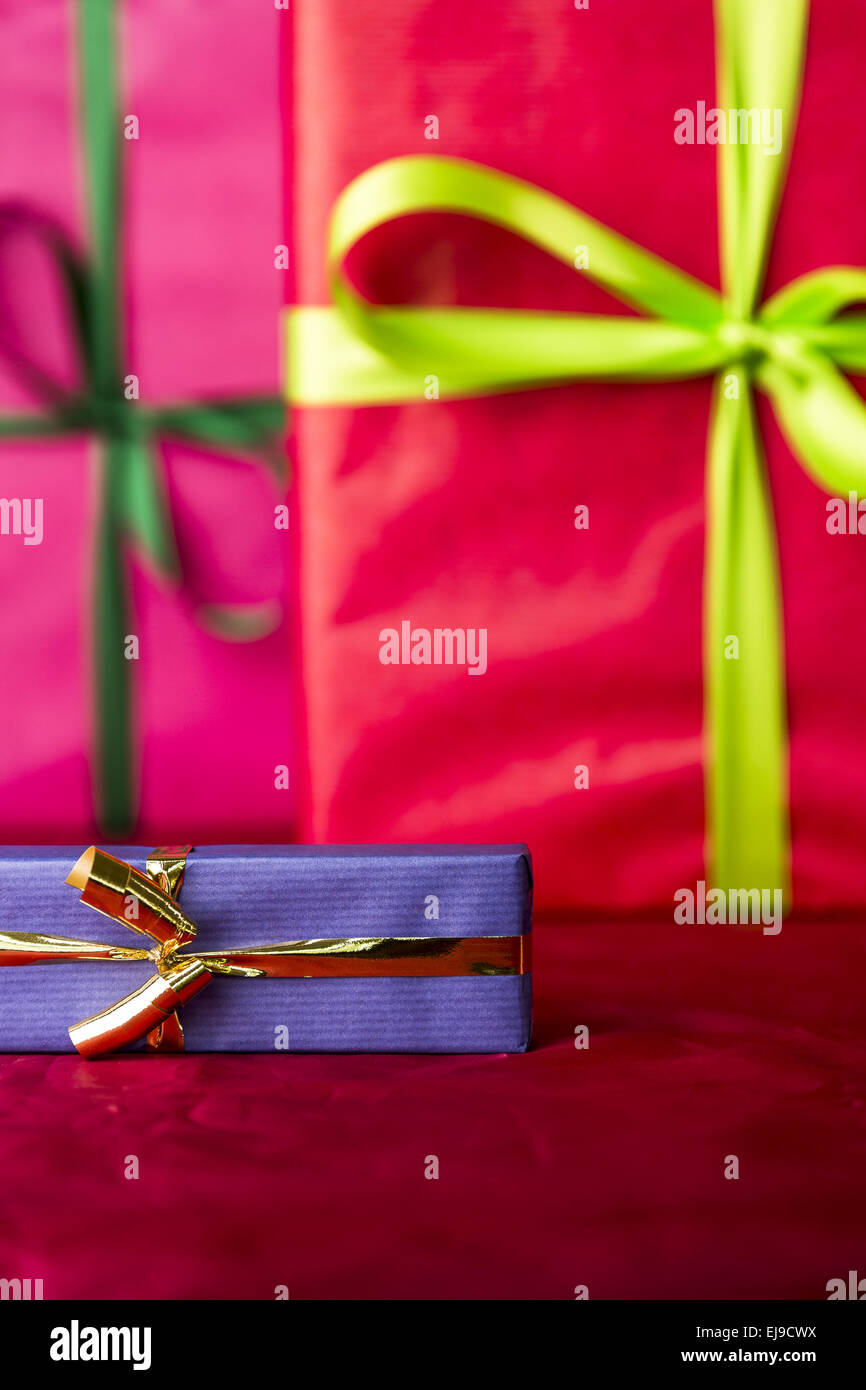 Blue present on red Stock Photo - Alamy