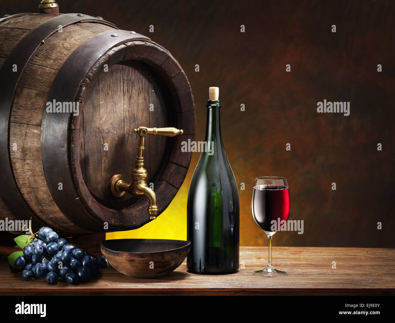 Still-life with glass of wine, bottle and barrel on the table in the ...