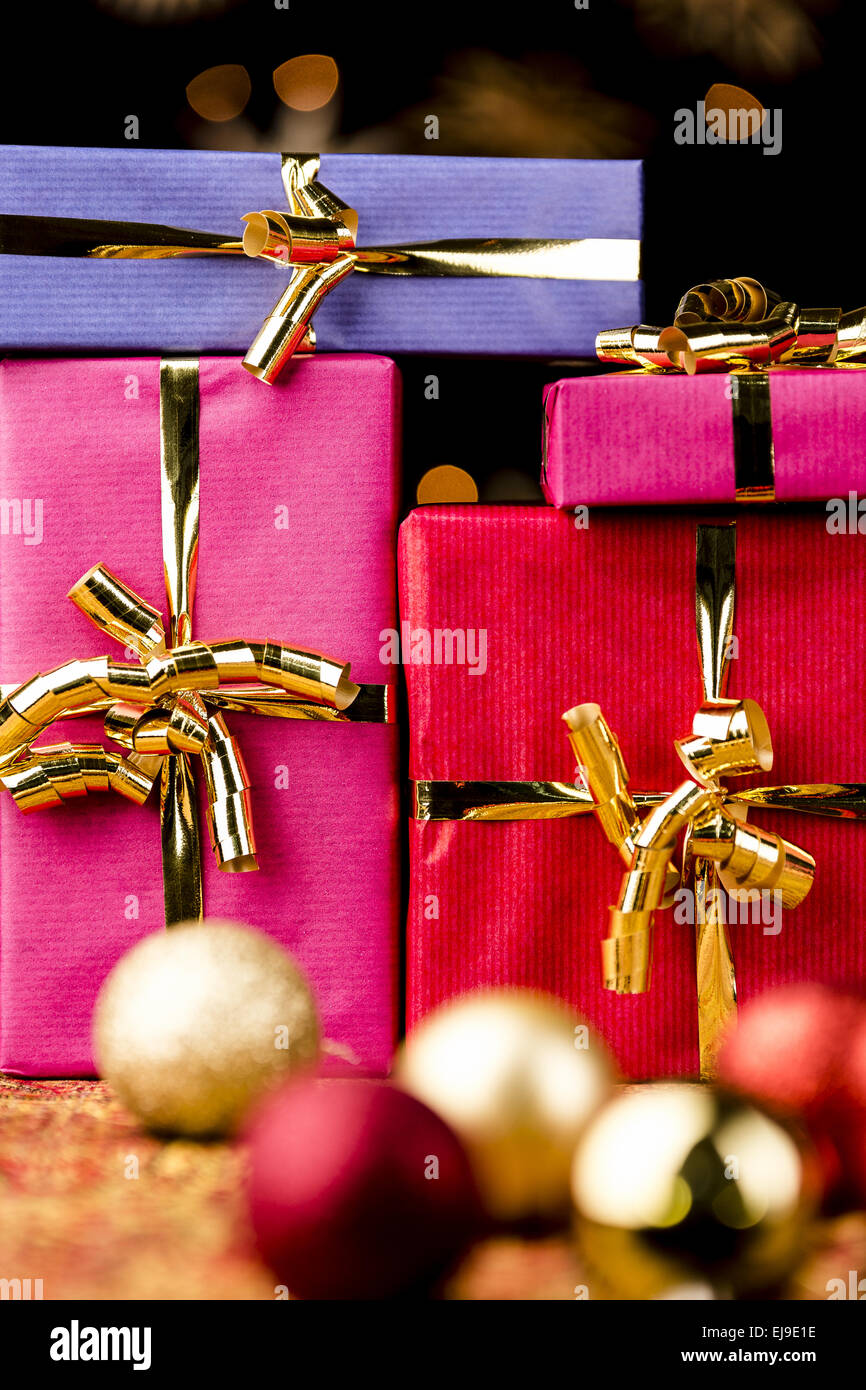 Four Solid Gift Boxes and Festive Spheres Stock Photo - Alamy