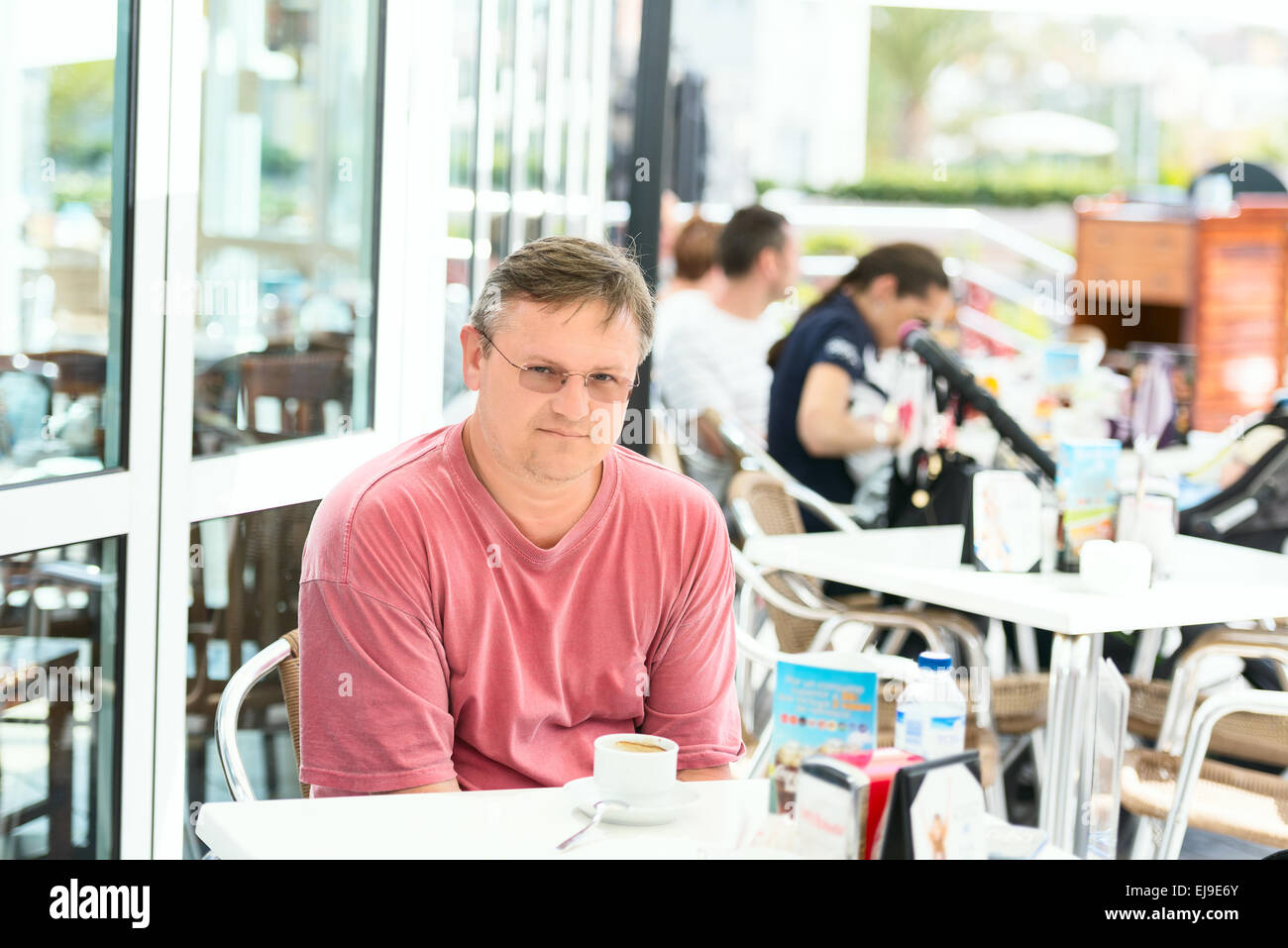 Men drinking coffee at outdoor cafe Stock Photo - Alamy