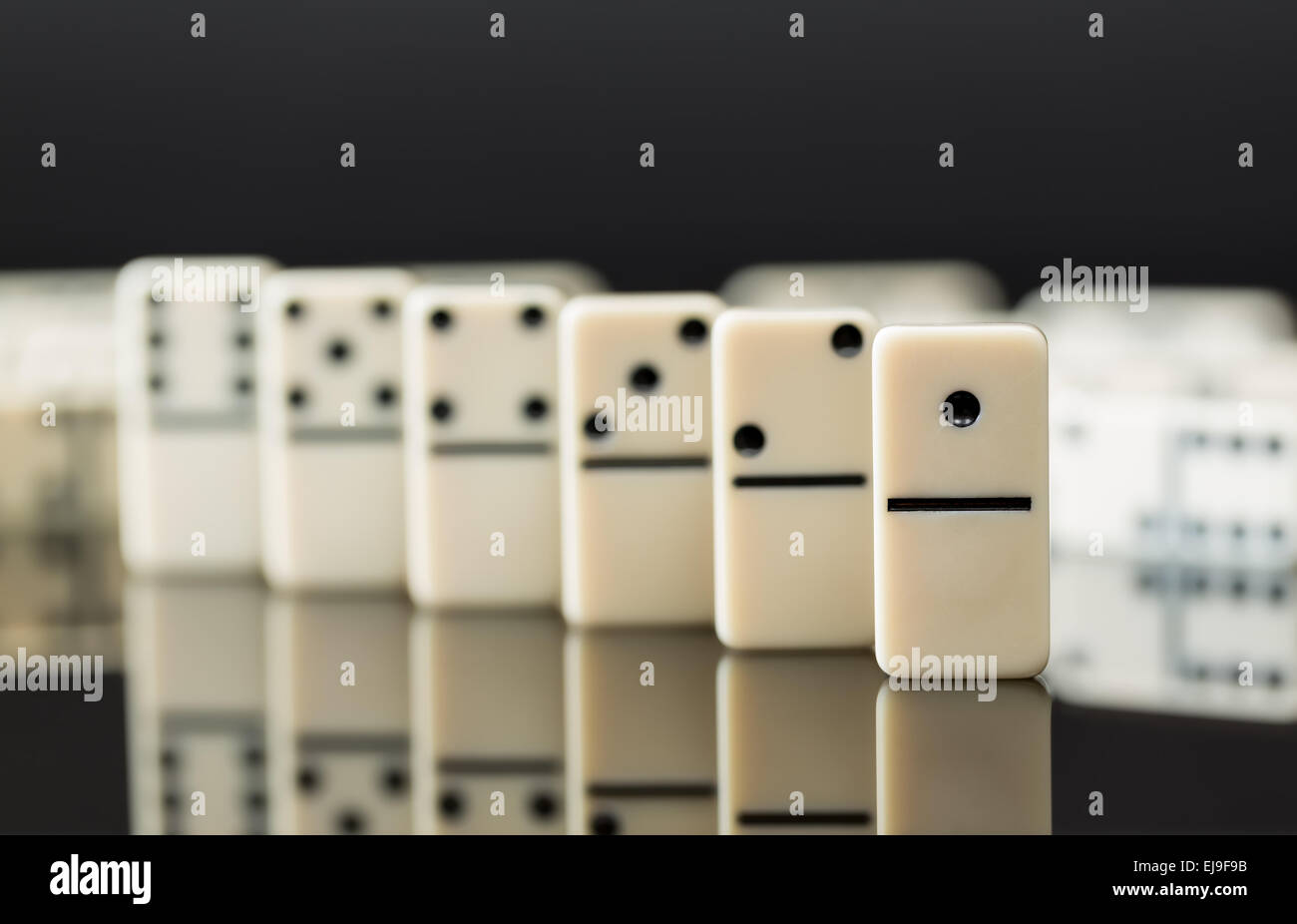 White dominoes showing leader or winner Stock Photo - Alamy