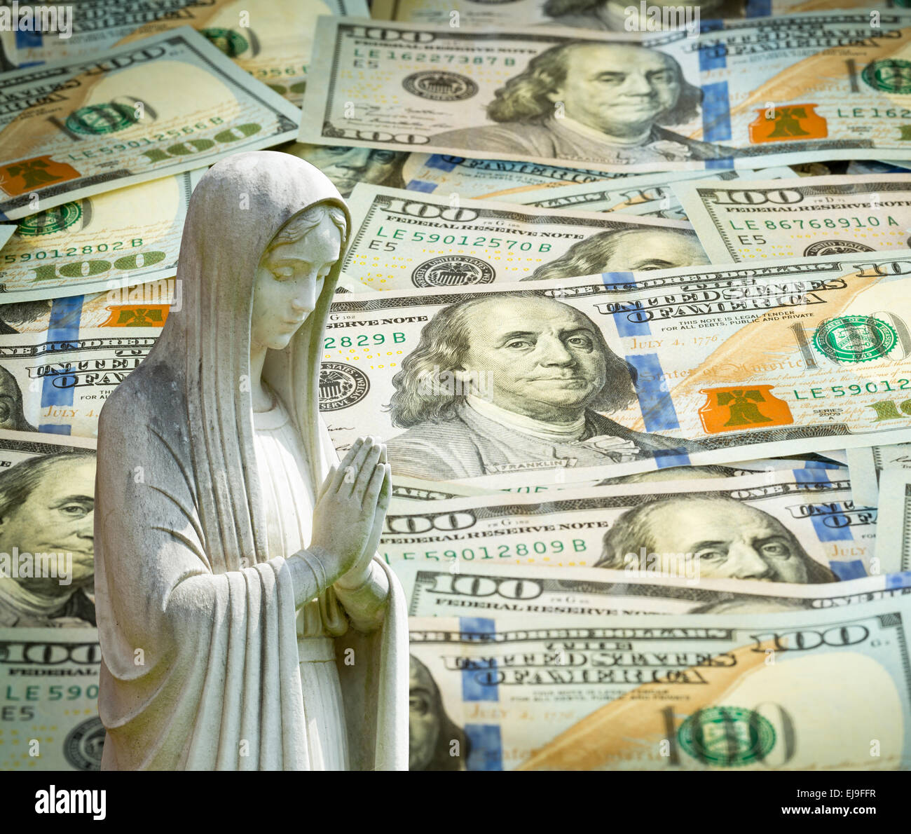 Praying statue with cash background Stock Photo - Alamy