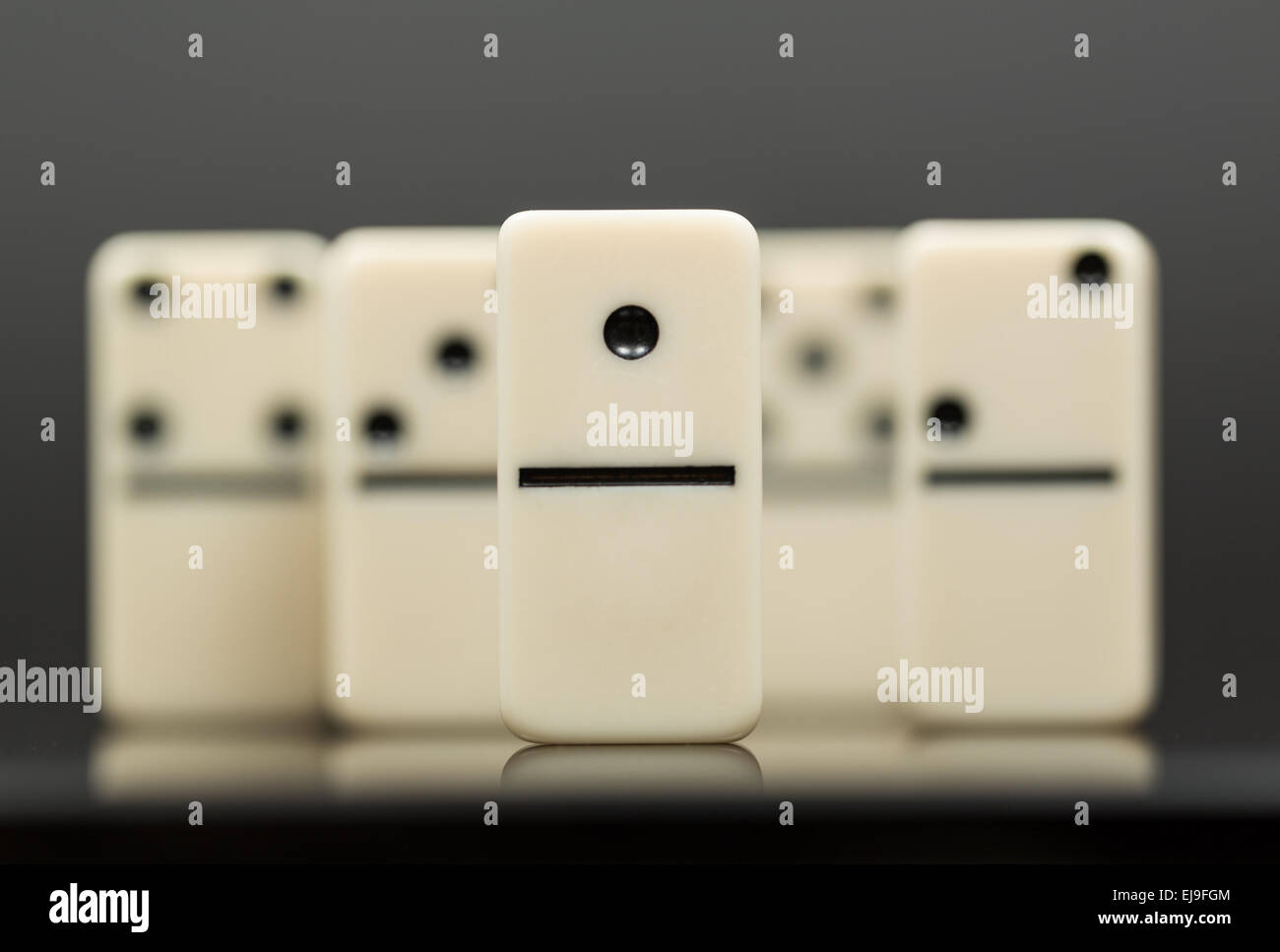 White dominoes showing leader or winner Stock Photo - Alamy