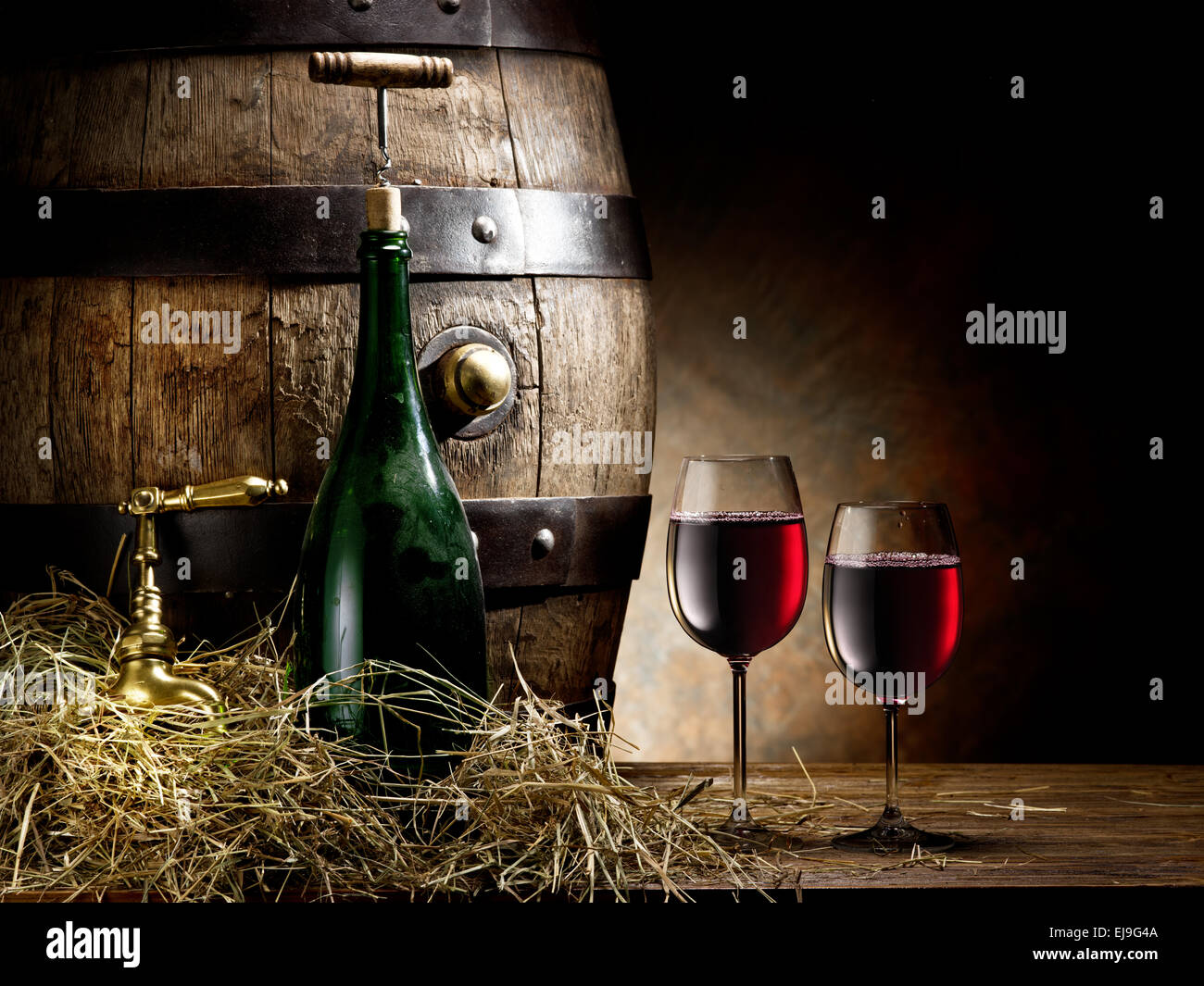 Still-life with glass of wine, bottle and barrel on the table in the ...