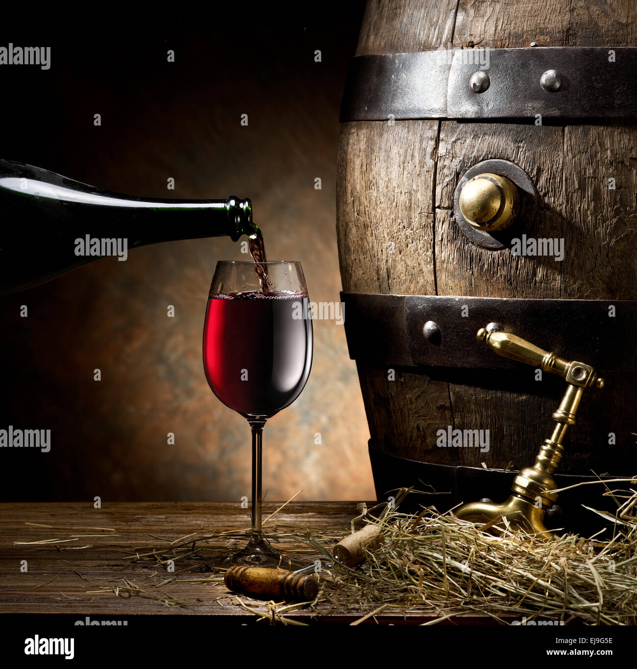 Still-life with glass of wine, bottle and barrel on the table in the ...