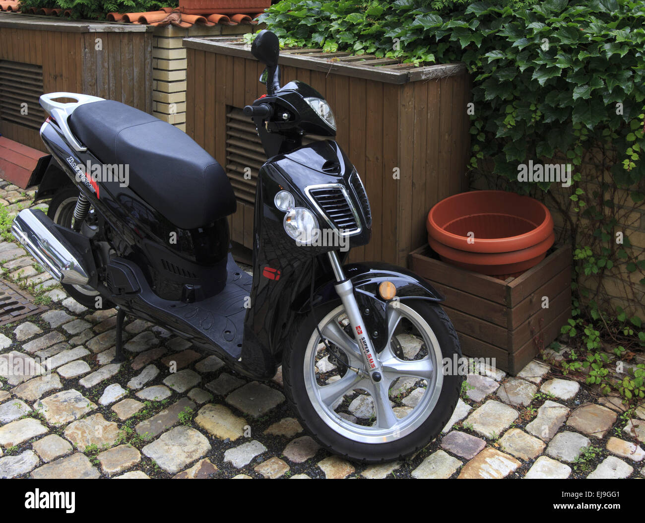 Black modern moped near the fence Stock Photo - Alamy