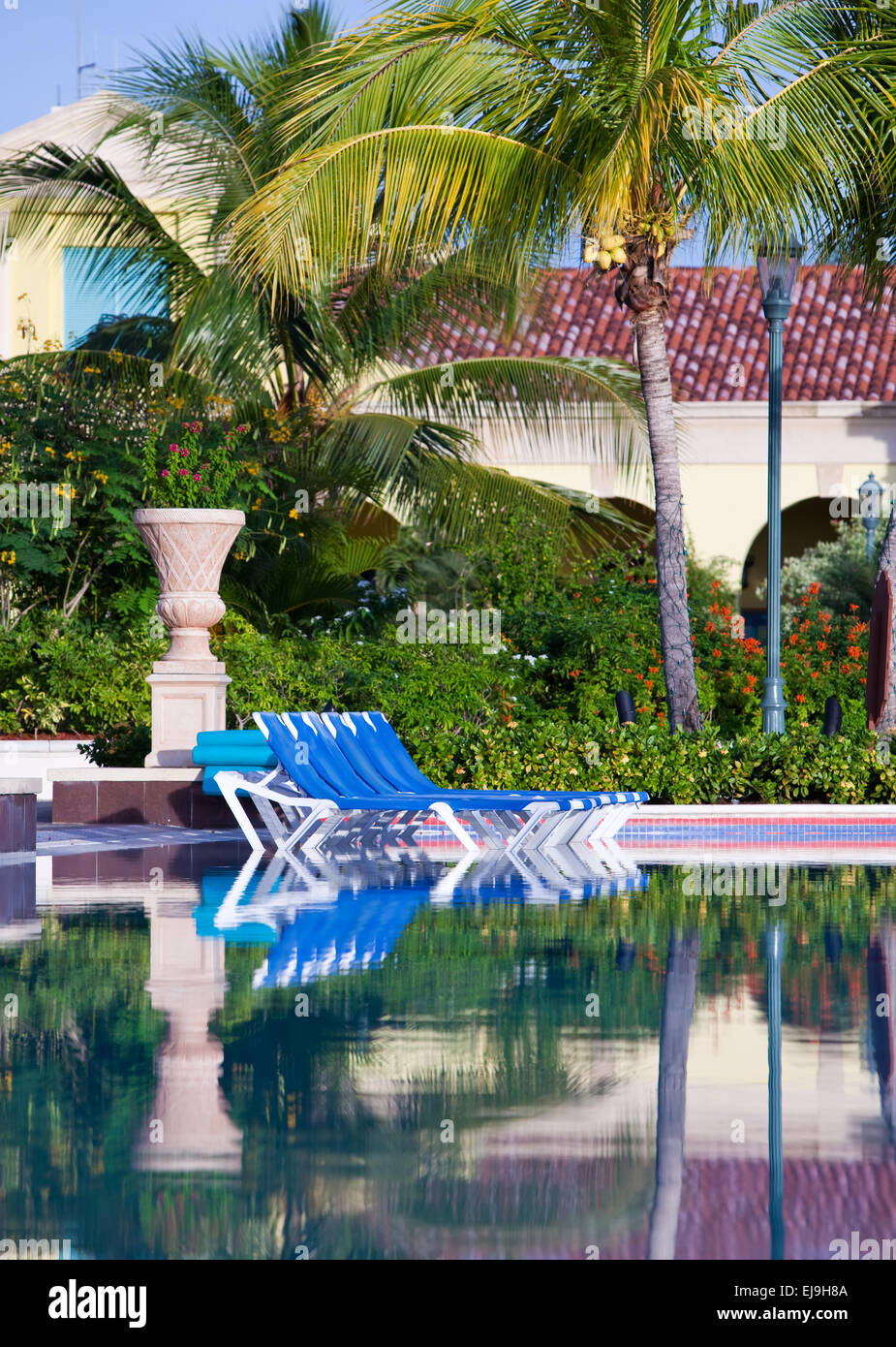 Empty beach chair before pool Stock Photo - Alamy