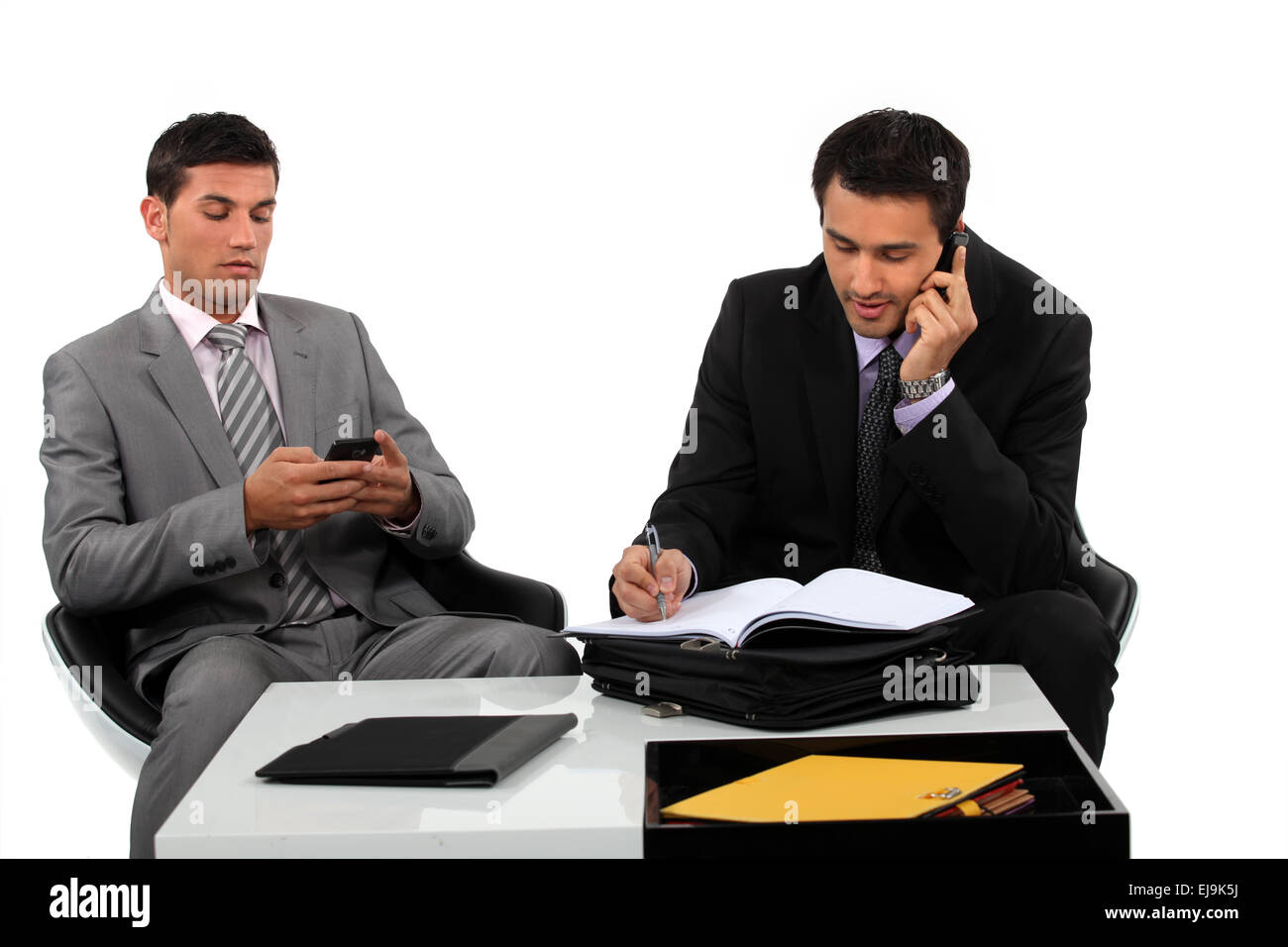 Two businessmen waiting in the lobby Stock Photo - Alamy