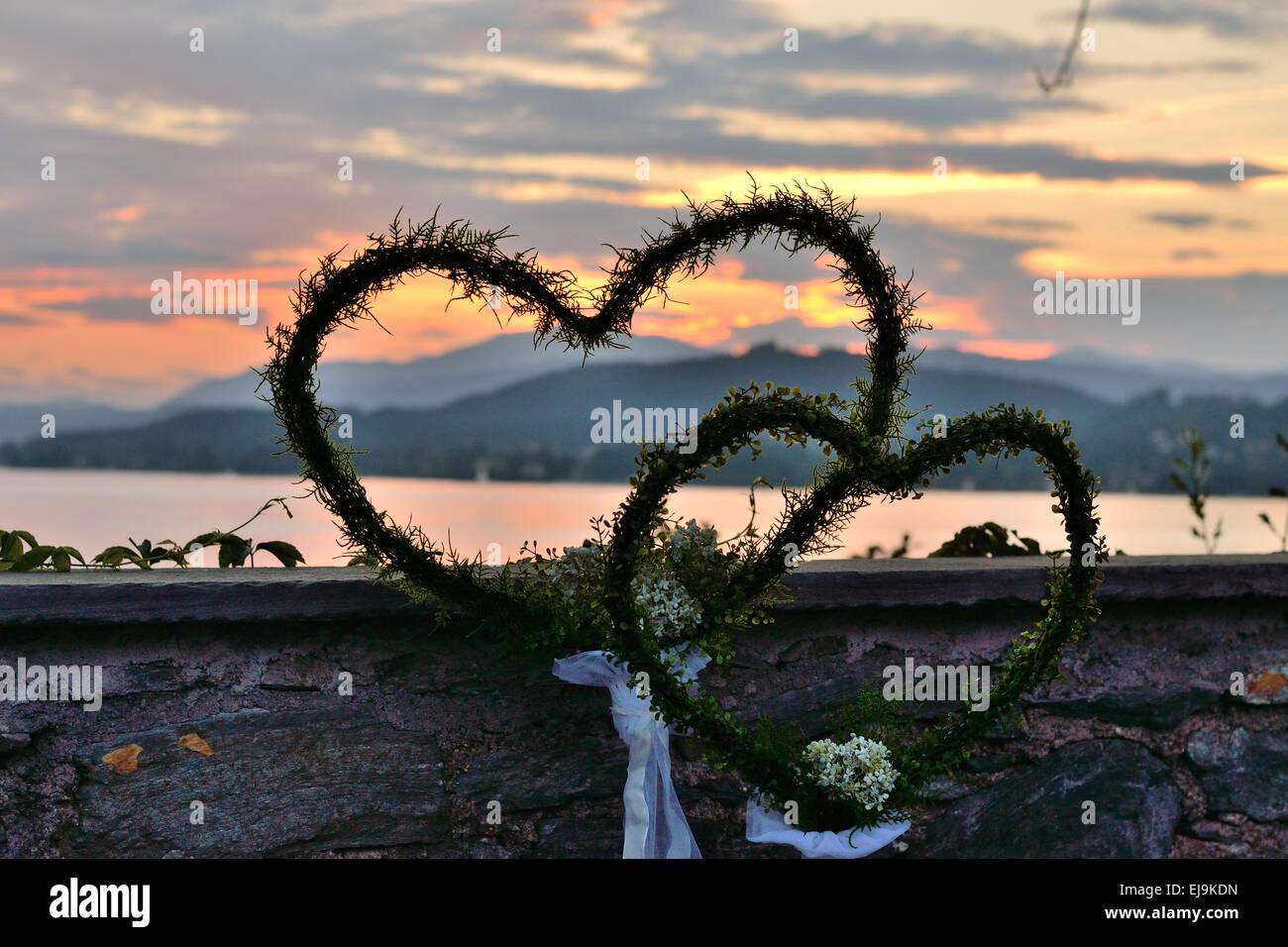 two hearts wedding at sunset on the lake Stock Photo - Alamy
