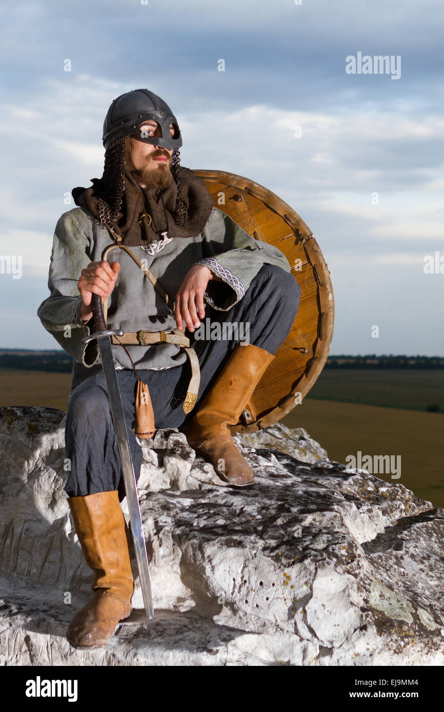 Knight sitting on a rock Stock Photo - Alamy