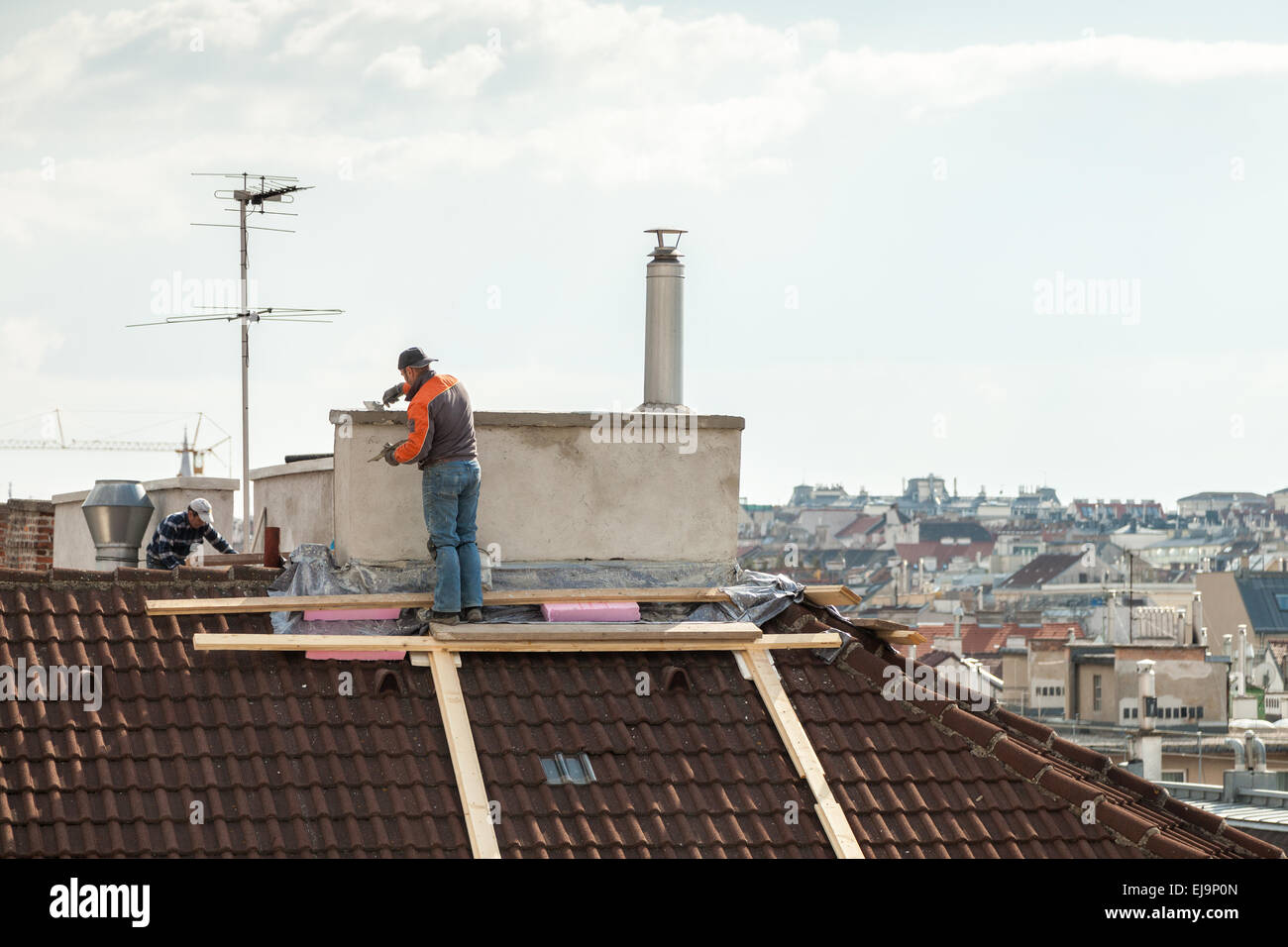 Worker on the roof Stock Photo - Alamy