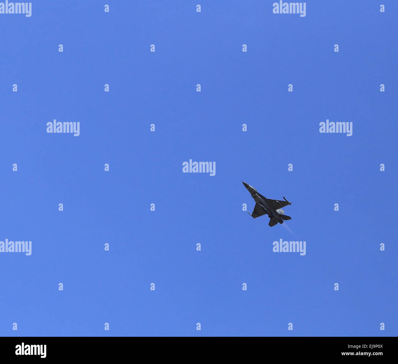 f16 falcon fighter jet flying on blue sky background Stock Photo - Alamy