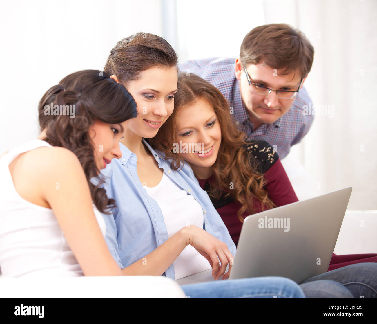 four students and a laptop Stock Photo - Alamy