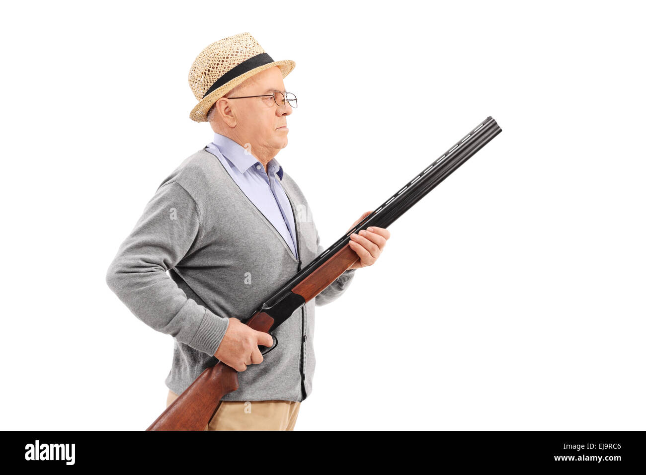 Senior gentleman with hat holding a rifle and standing in a row ...