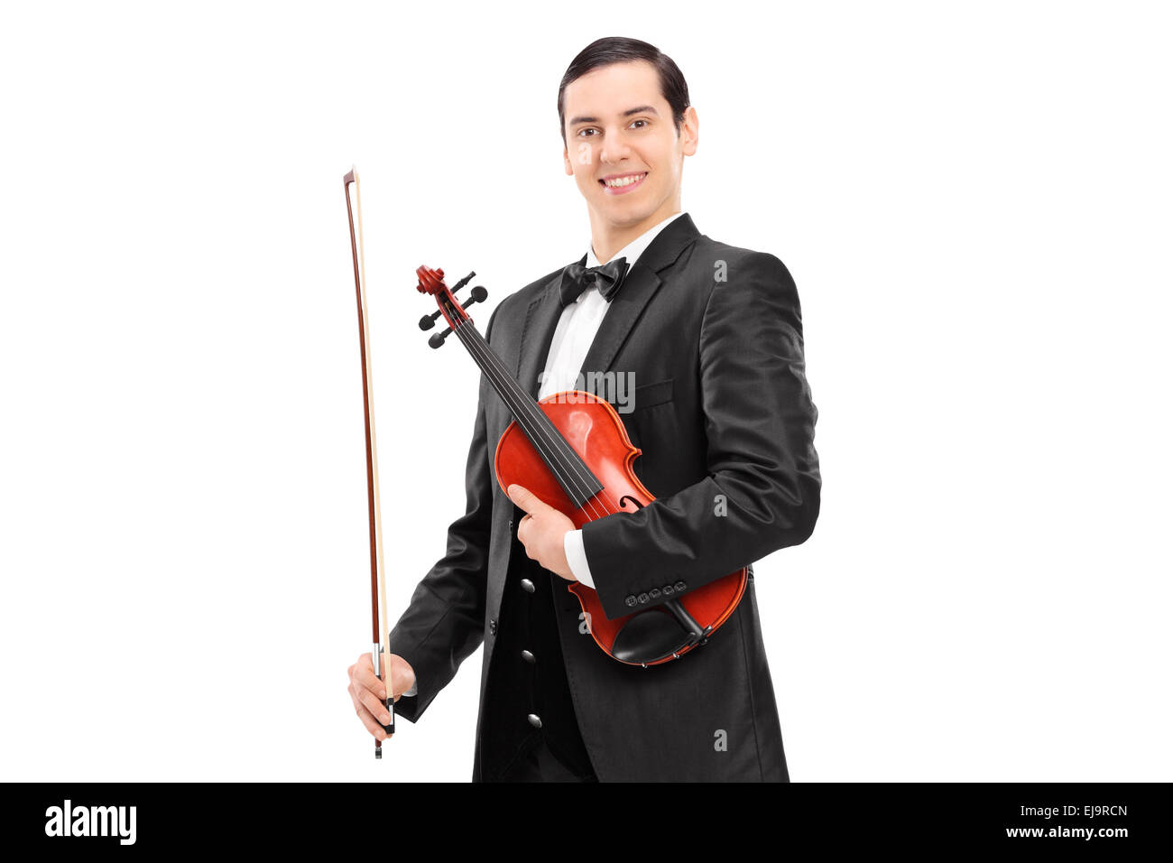 Young confident violinist in black suit holding a wand and a violin ...
