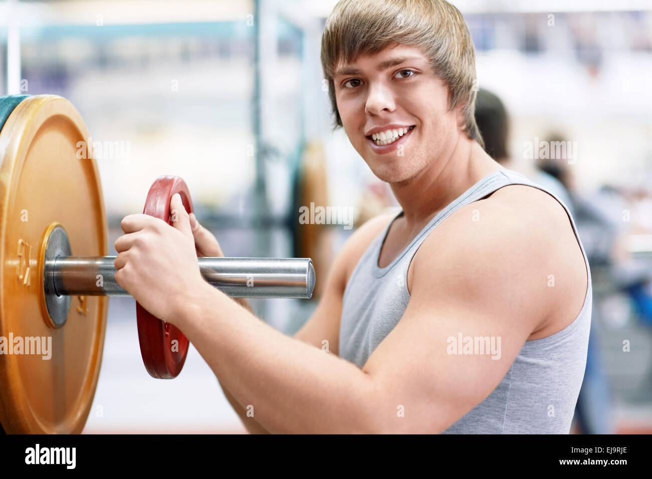 Young man in fitness club Stock Photo - Alamy