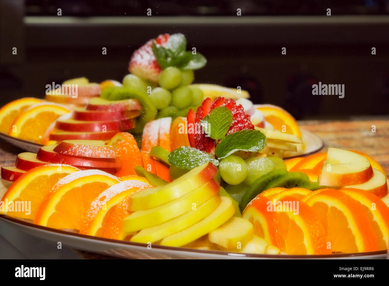 cutting fruits on plate. sweet food Stock Photo - Alamy
