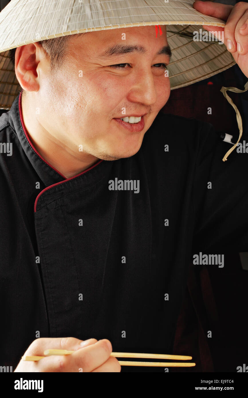 Smiling guy with chopsticks Stock Photo - Alamy