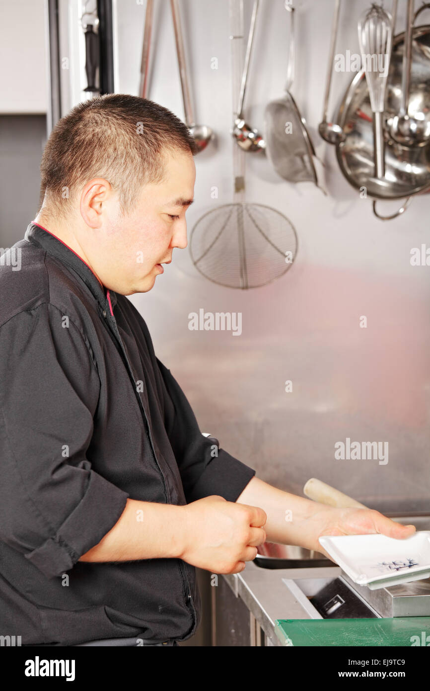 Chef weighs emply plate Stock Photo - Alamy