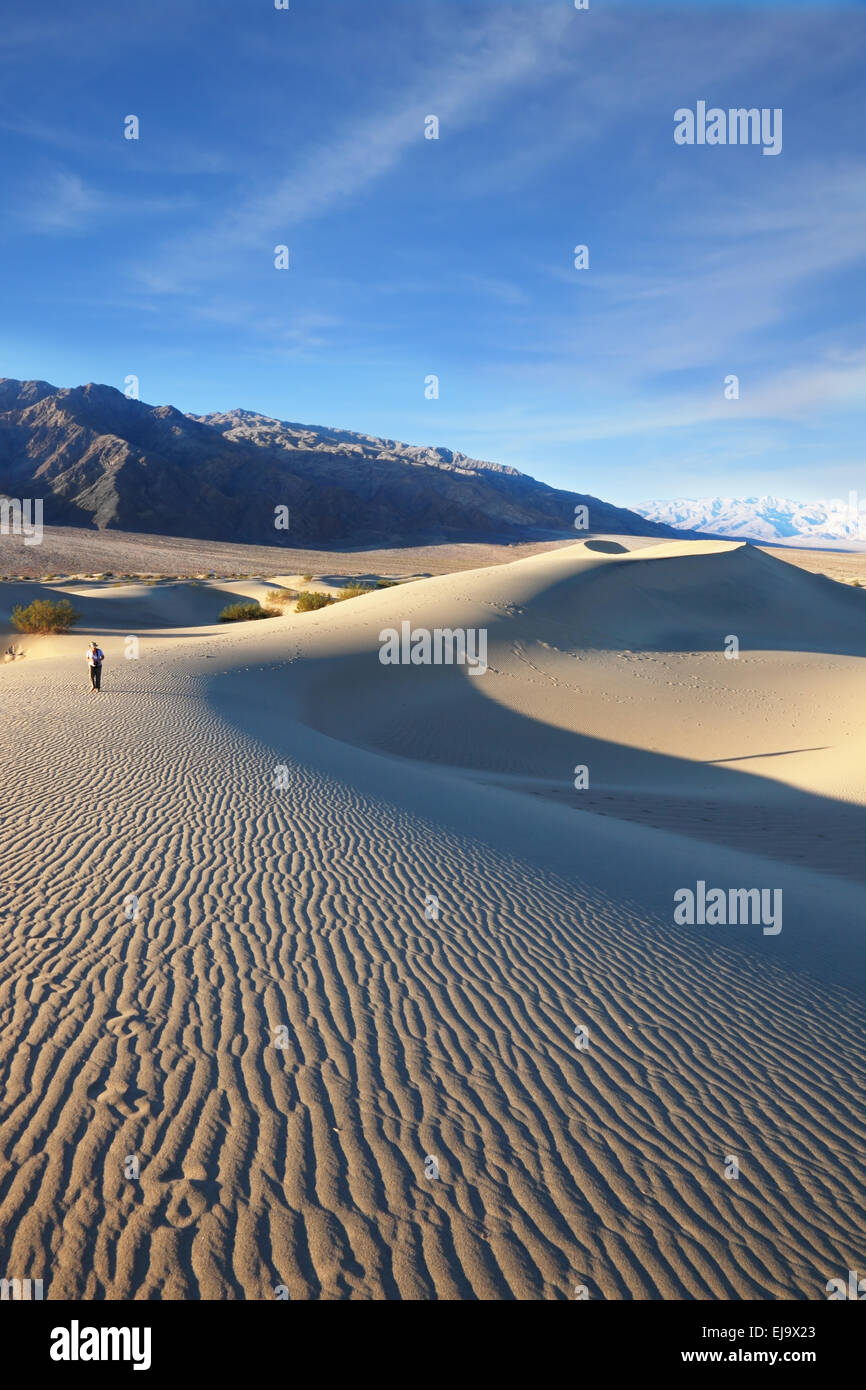 Woman photographer photographing sand waves Stock Photo - Alamy