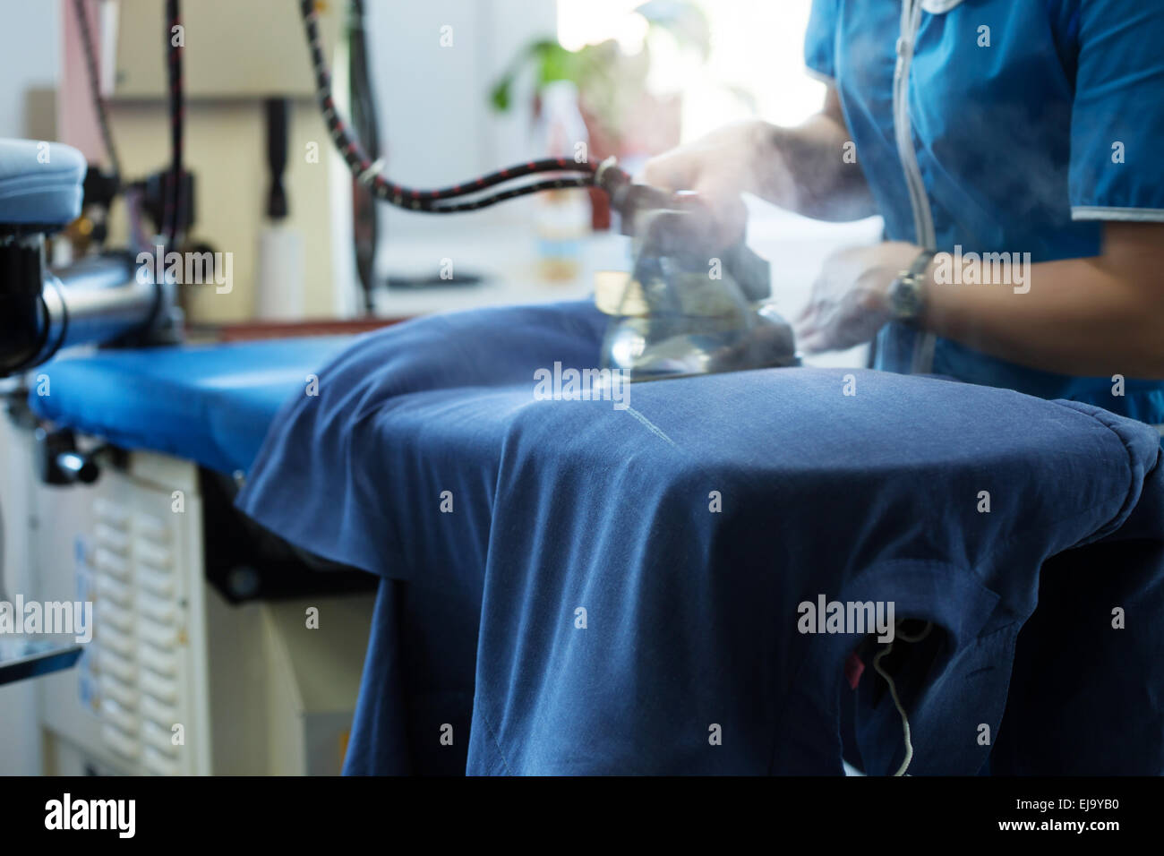 Image of laundry worker at work Stock Photo - Alamy