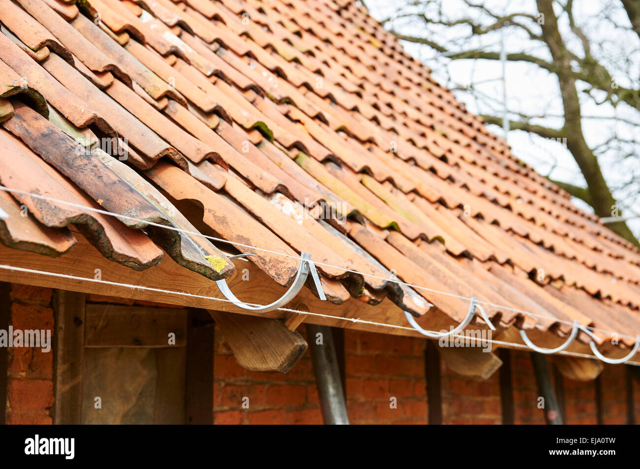 Aligned rain gutter hanger Stock Photo - Alamy
