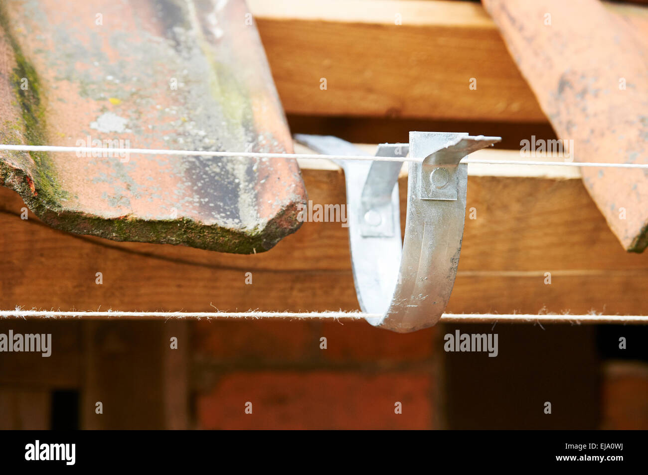 Aligned rain gutter hanger Stock Photo - Alamy