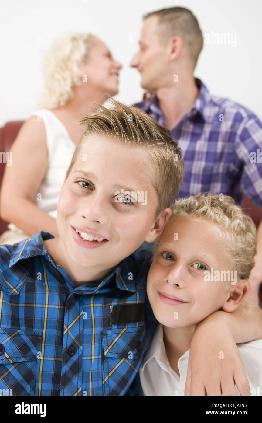 brothers with parents in the background Stock Photo - Alamy