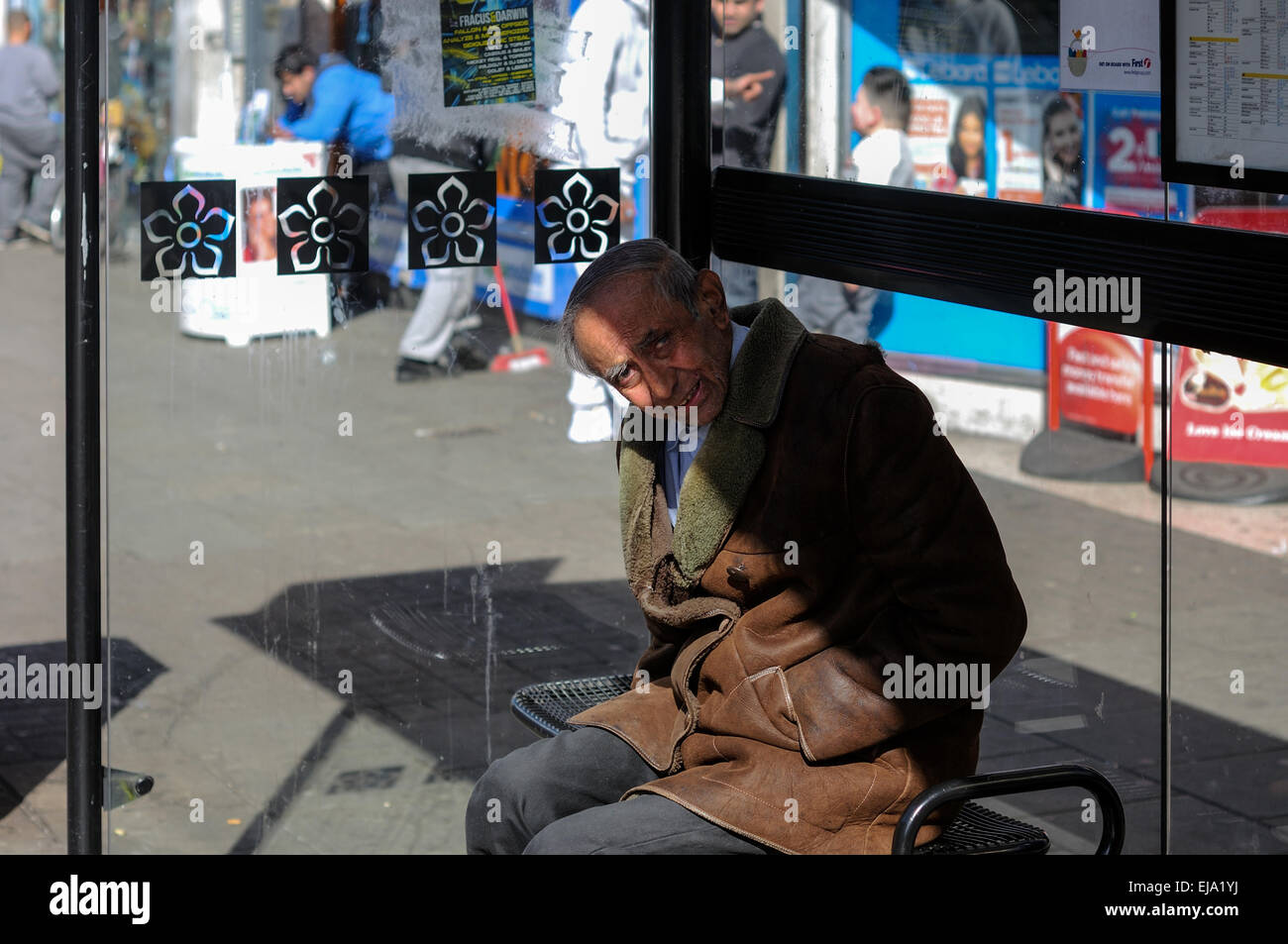 Man Sitting At Bus Stop Stock Photo - Alamy