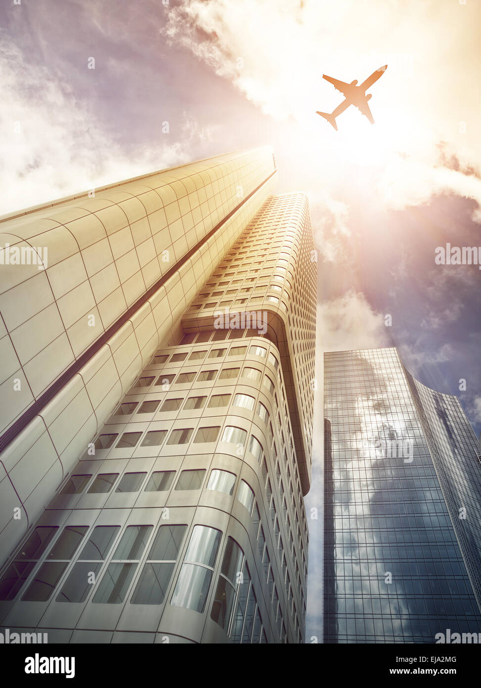 plane flying over modern office skyscrapers Stock Photo - Alamy