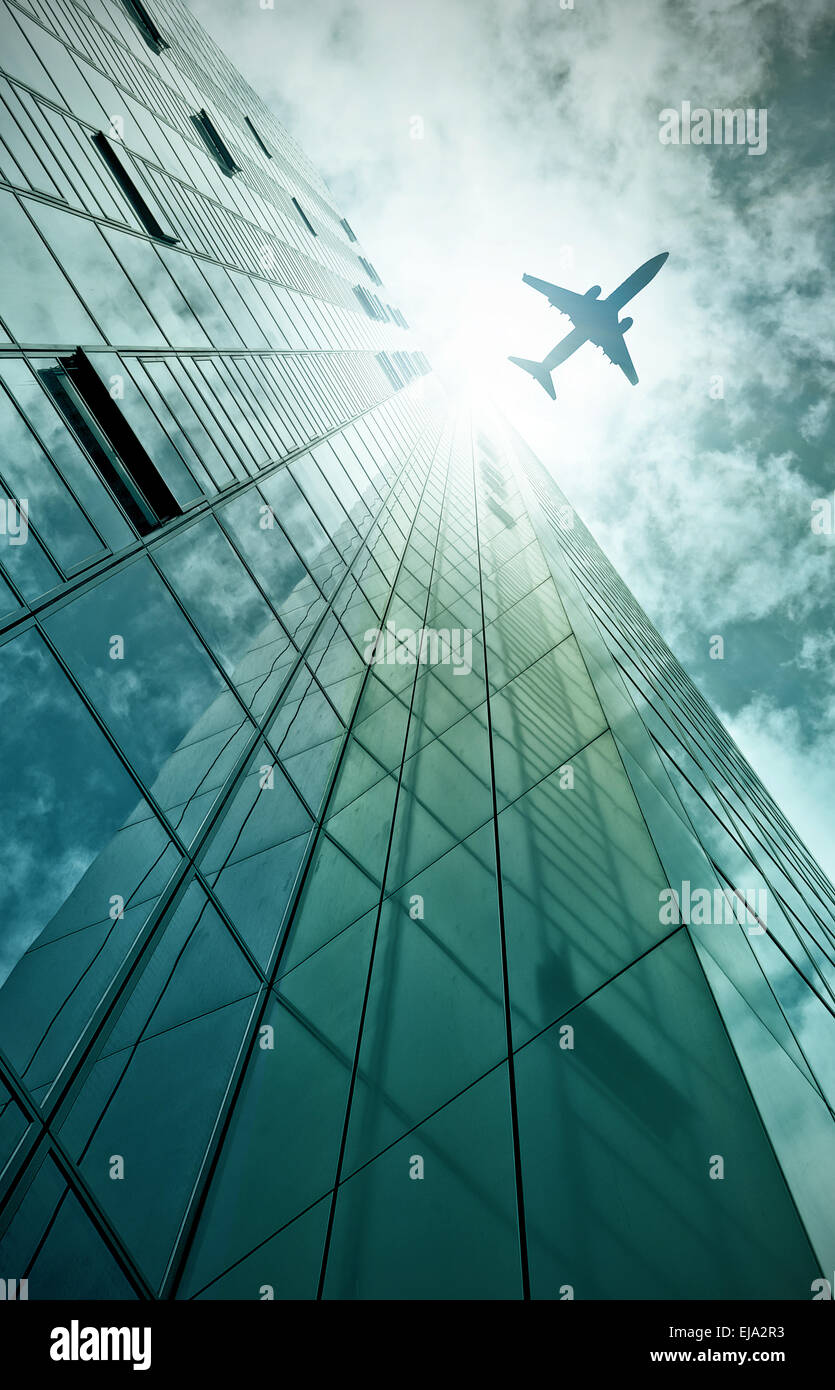 plane flying over office building Stock Photo - Alamy