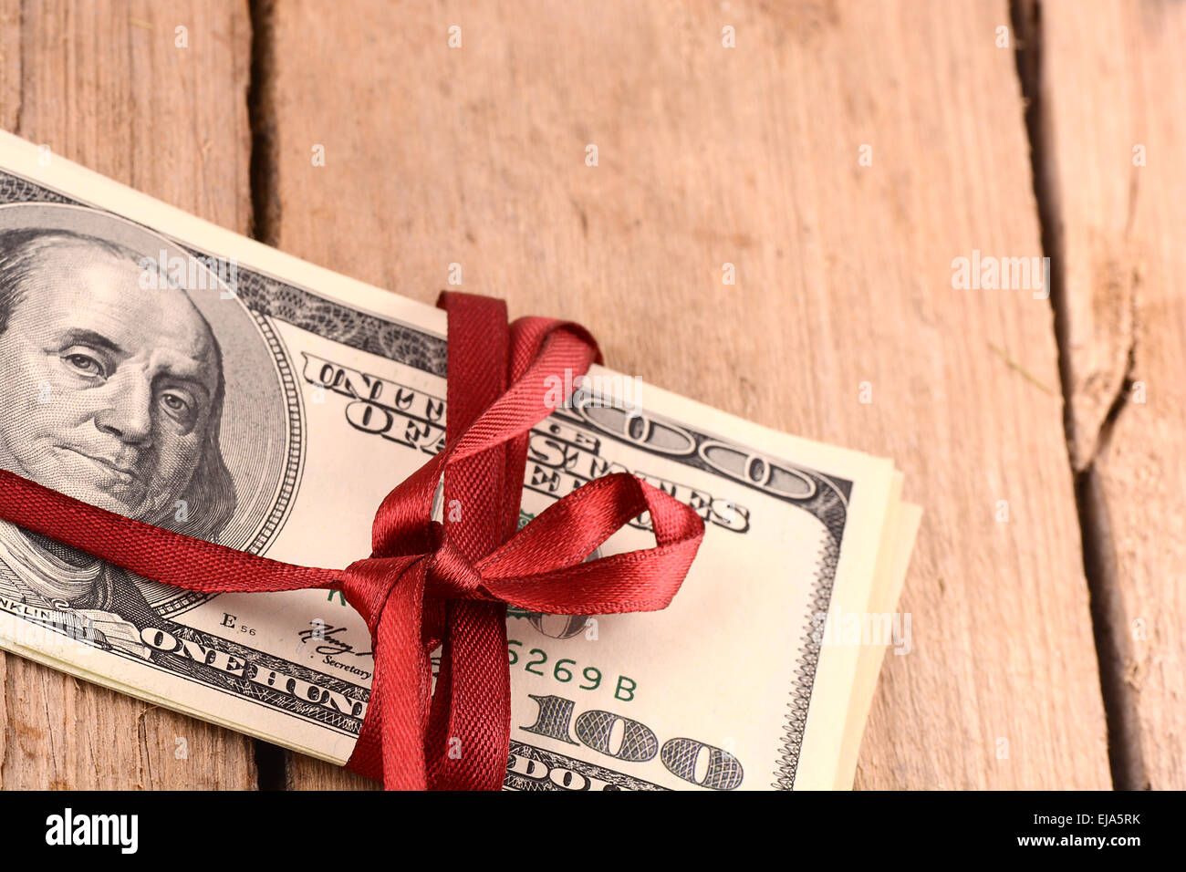 dollars wraped up with a red ribbon isolated on white background Stock ...