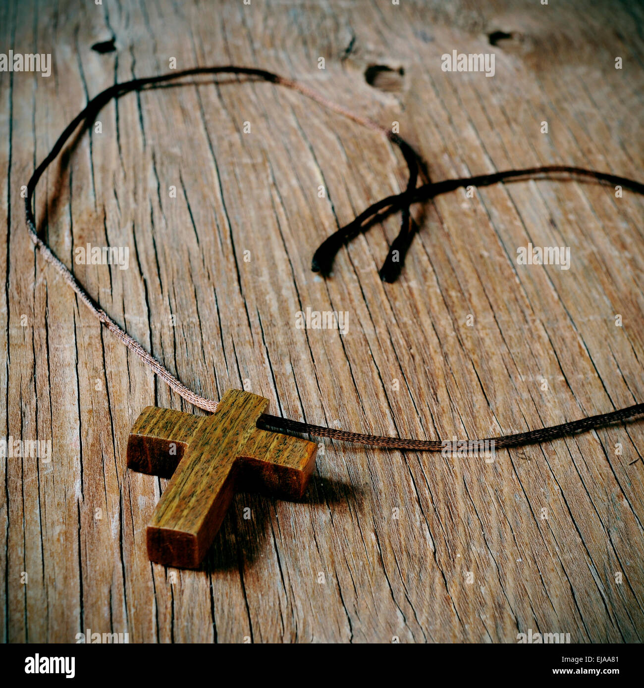 a simple wooden Christian cross on a rustic wooden surface Stock Photo ...