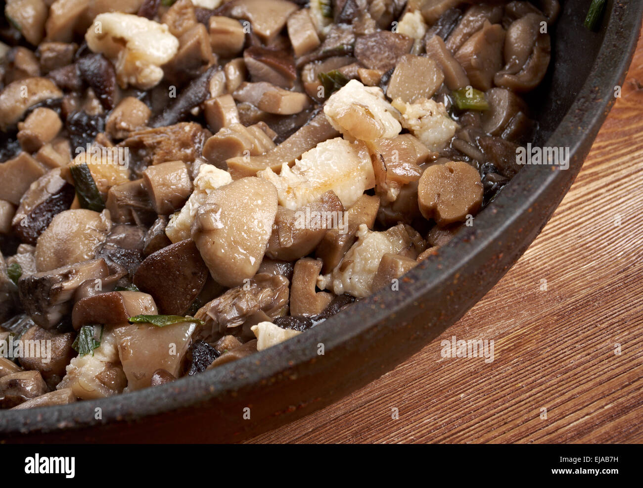 Delicious fried mushrooms in pan Stock Photo - Alamy