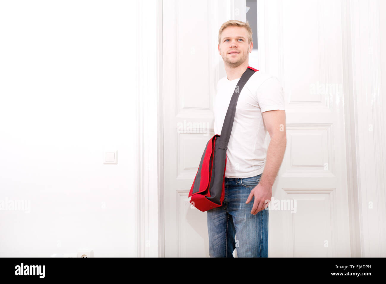 Young man coming home Stock Photo - Alamy