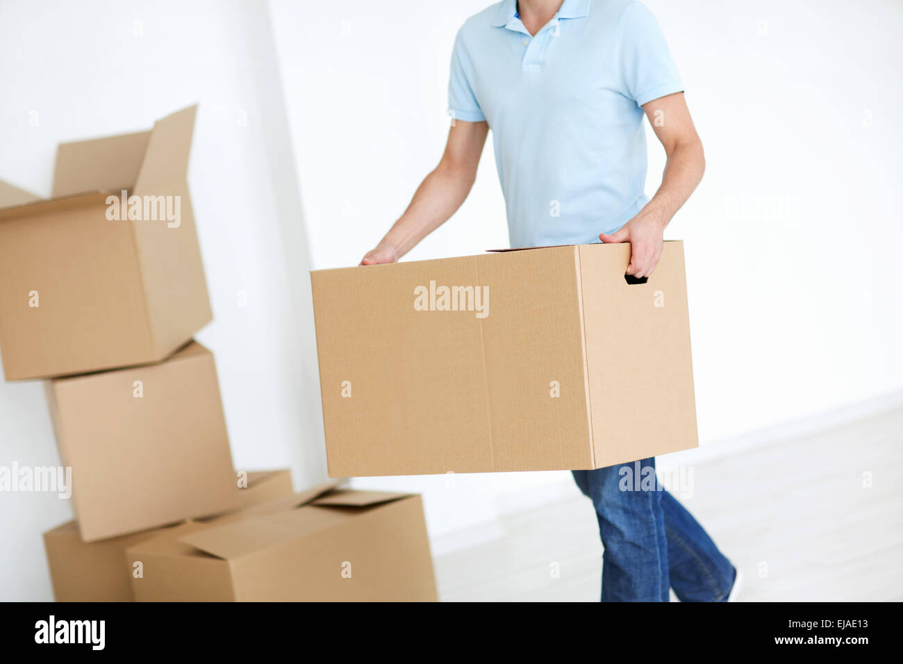 Man with a box indoors Stock Photo - Alamy