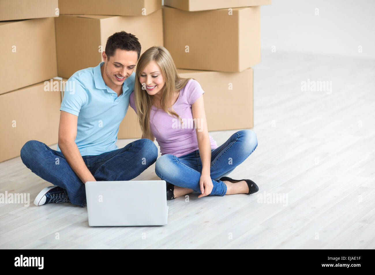 Couple with computer Stock Photo - Alamy