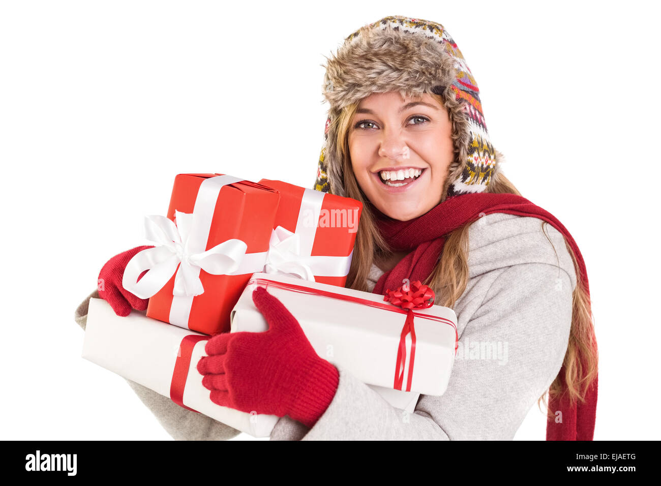 Happy blonde in winter clothes holding gifts Stock Photo - Alamy