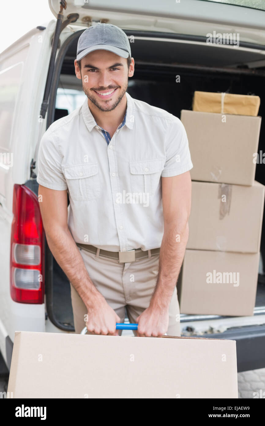 Delivery driver loading his van with boxes Stock Photo - Alamy