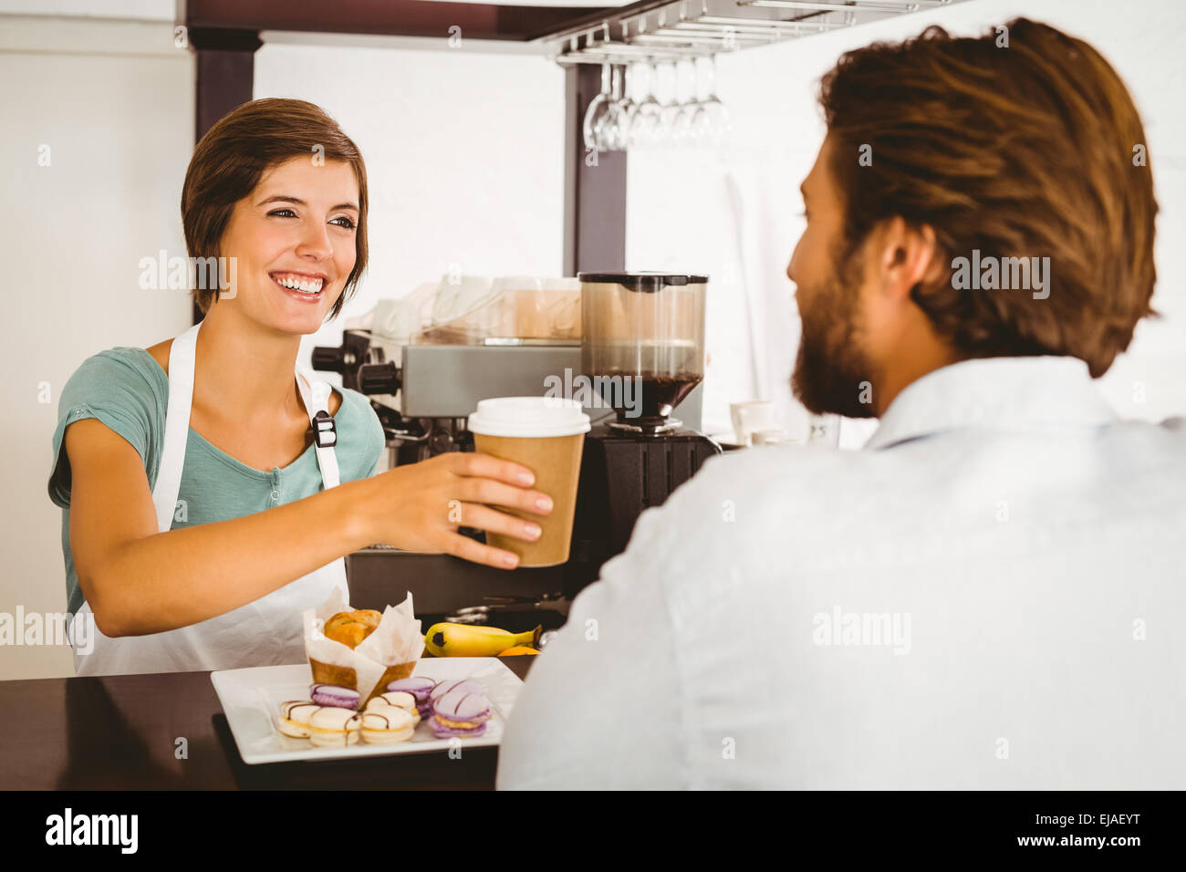 Pretty waitress serving happy customer Stock Photo - Alamy
